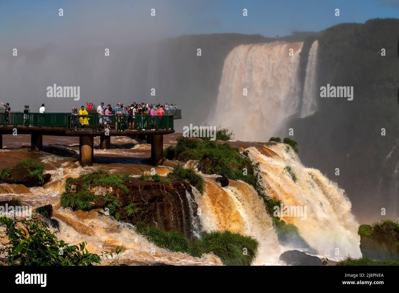 Tourists admiring the Iguazu Falls, one of the biggest falls in the ...