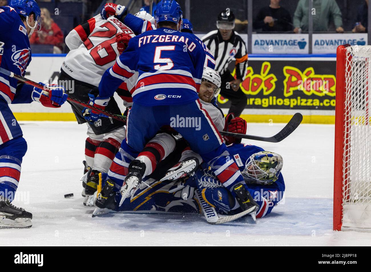 May 17, 2022: Utica Comets forward A.J. Greer (17) falls onto Rochester ...