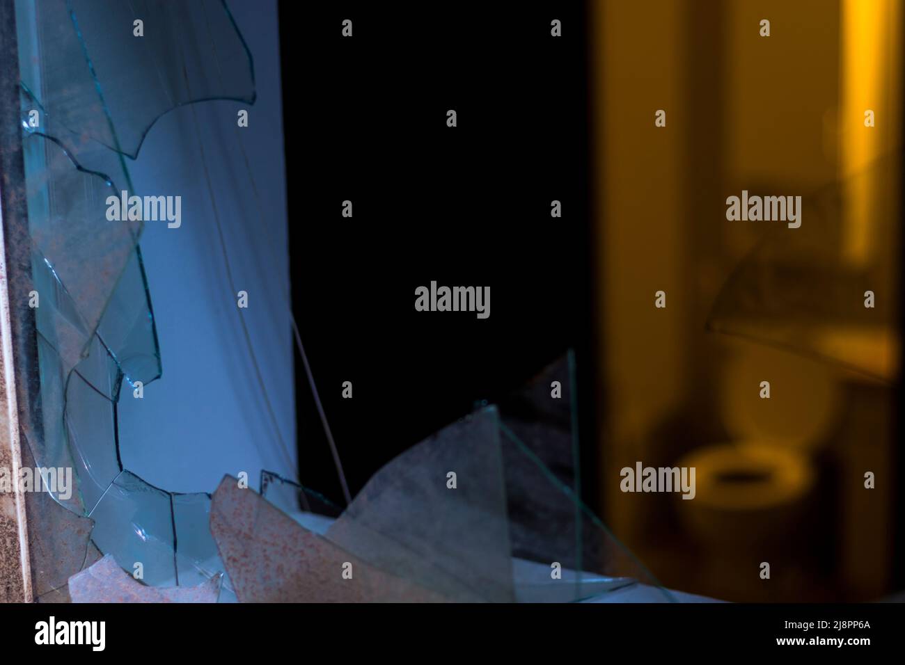 Broken window close up smashed glass. Intruder smashing window to break ...