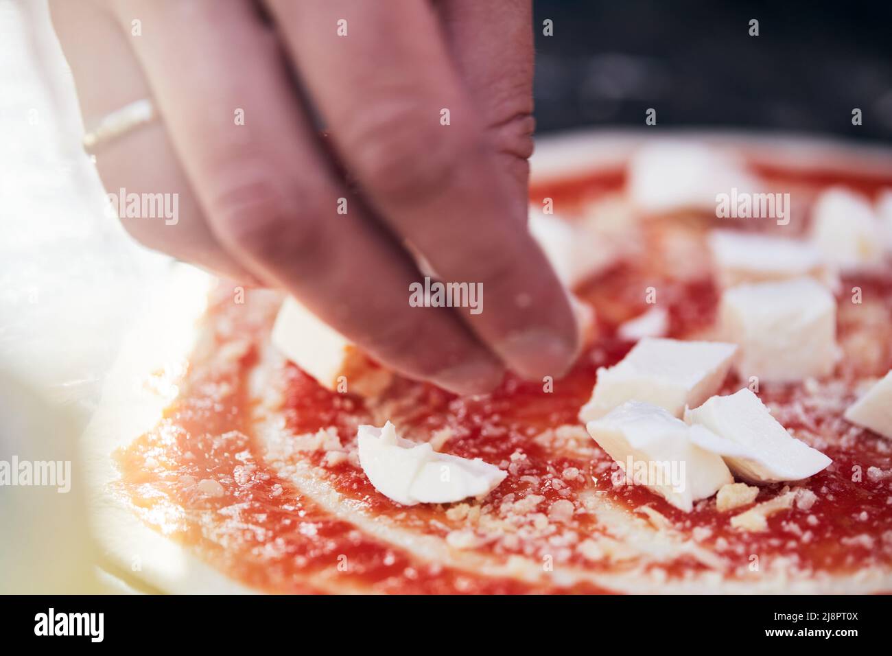 Cheese is placed on the pizza dough with sauce. The process of making ...