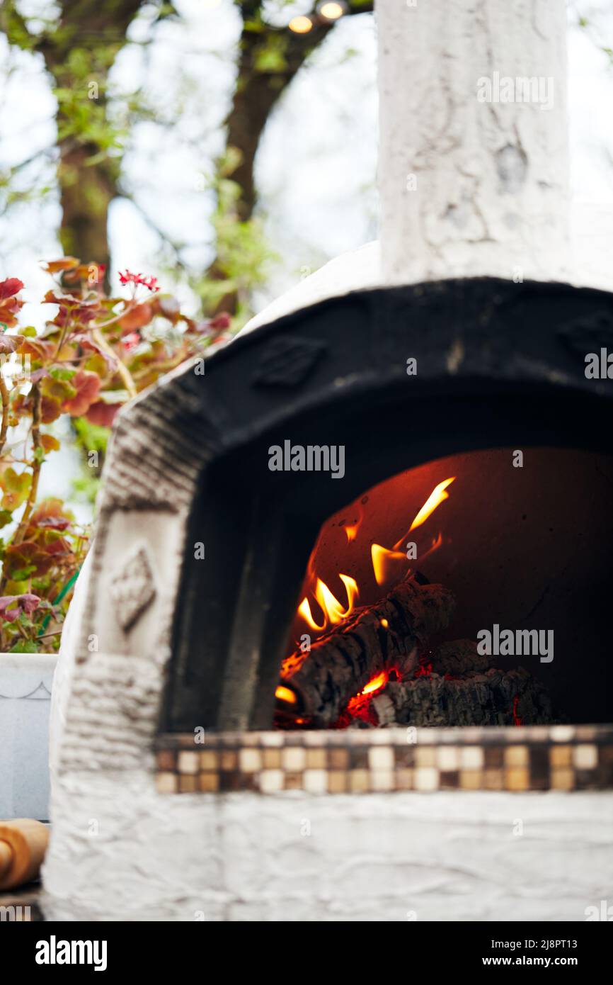 Wood-fired pizza oven with birch logs for kindling. The fire burns and ...