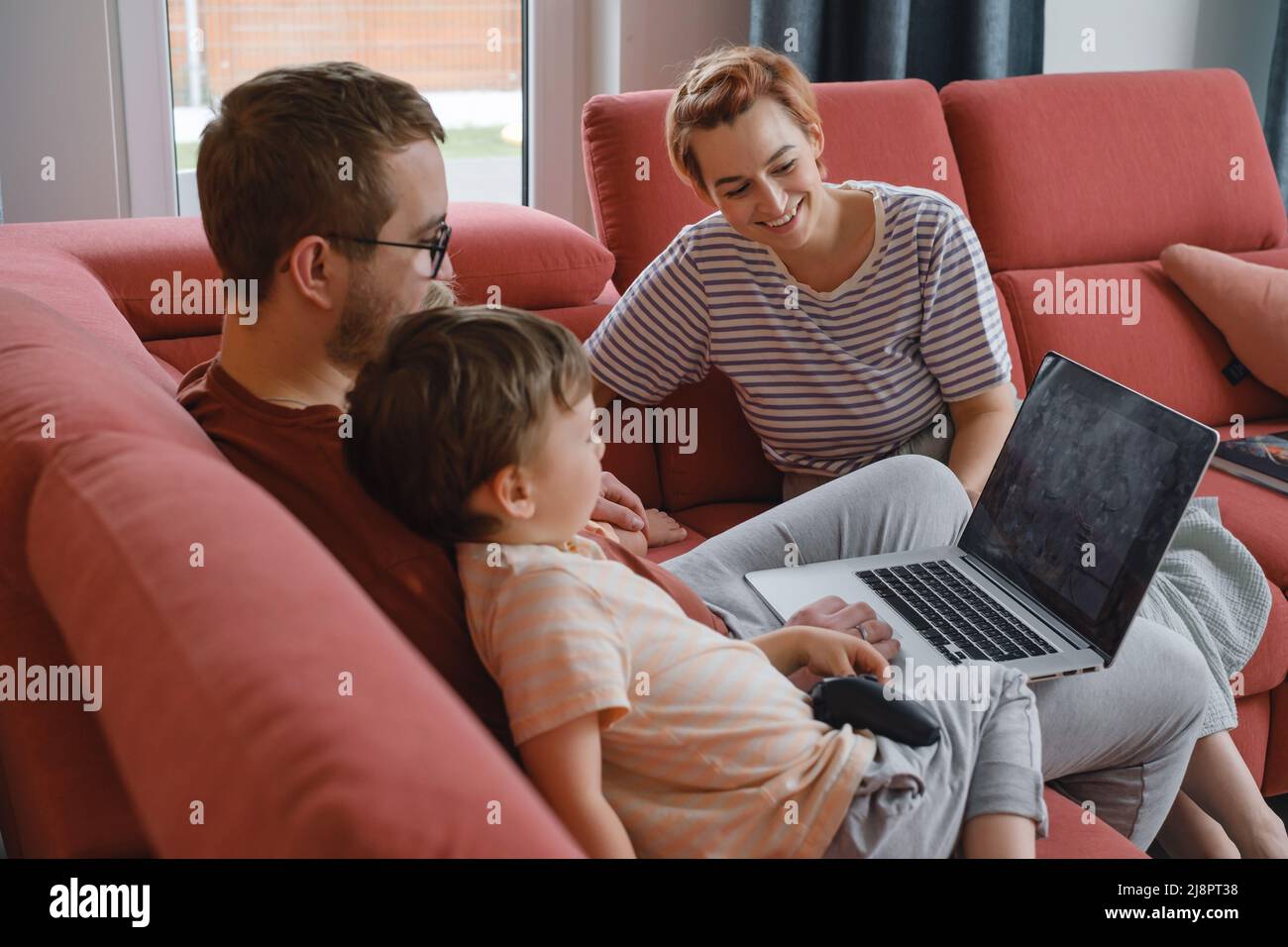Big happy family watching movies playing games on laptop. Mother father ...