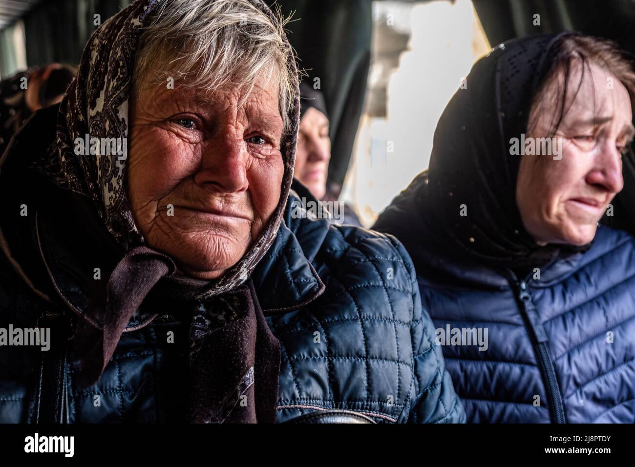 Women cry on a bus directed to Lviv cemetery for the funeral of two ...