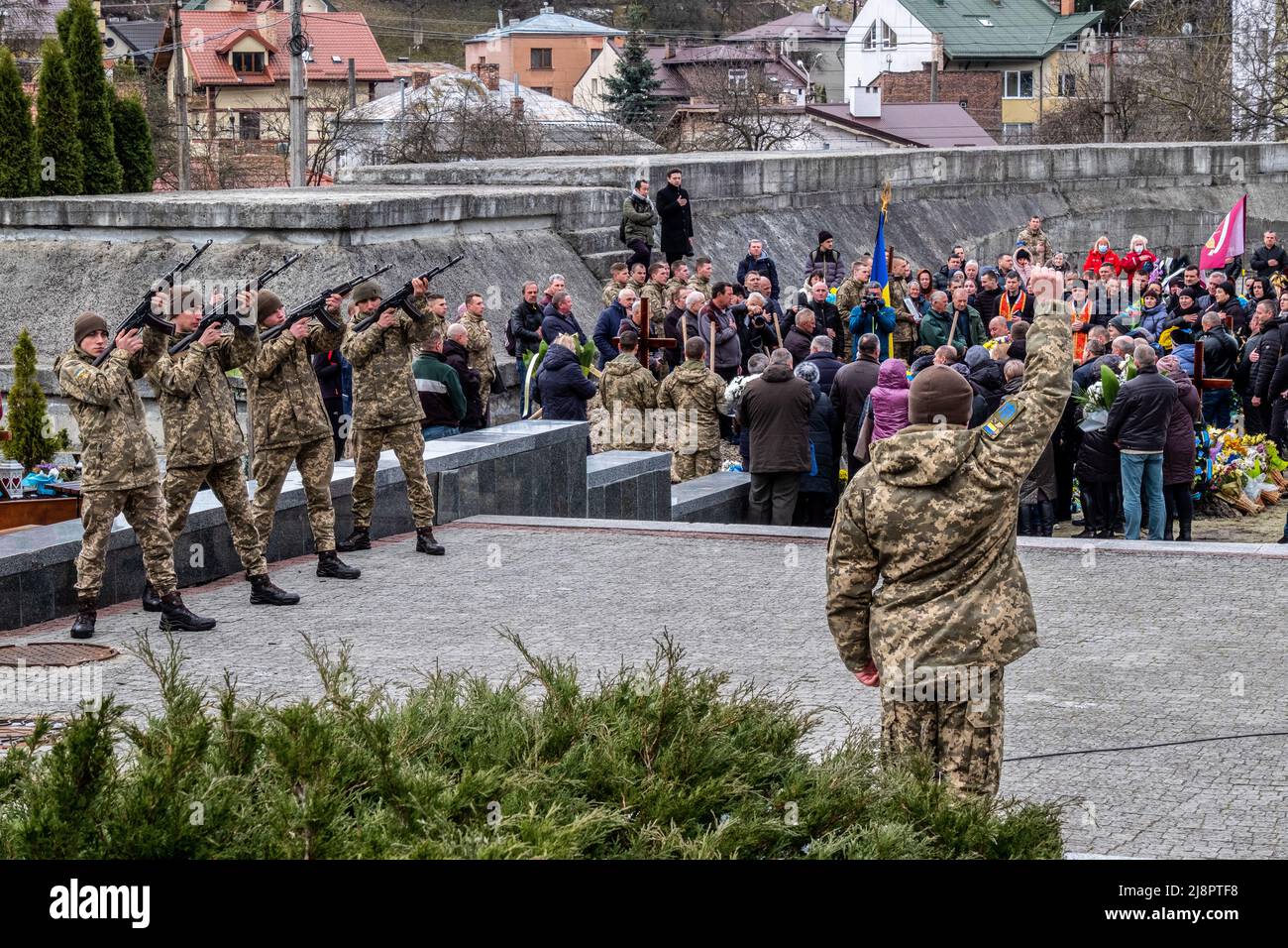 Soldiers fire three rifle volleys over the graves to honor the death of ...