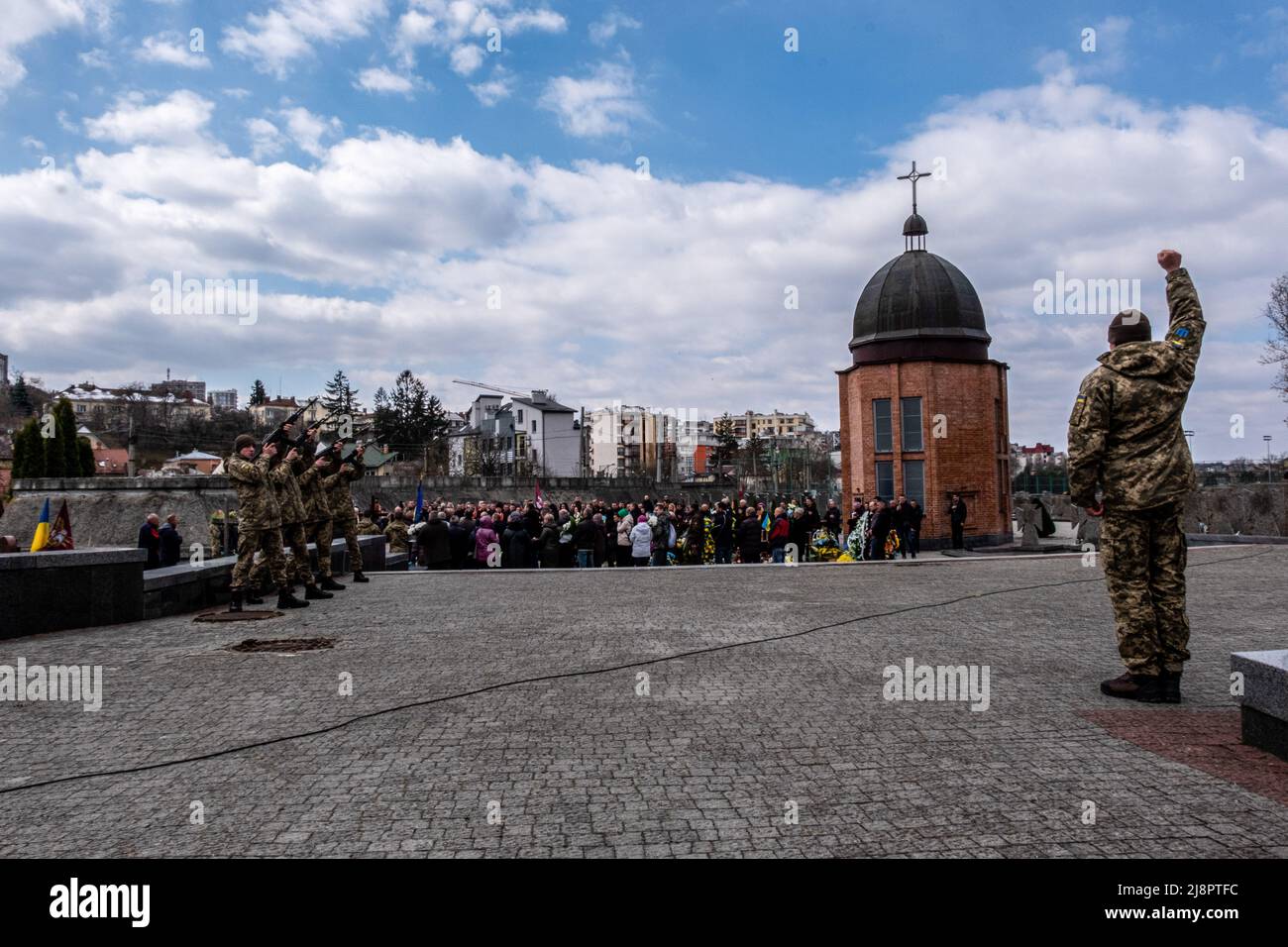 Soldiers fire three rifle volleys over the graves to honor the death of ...