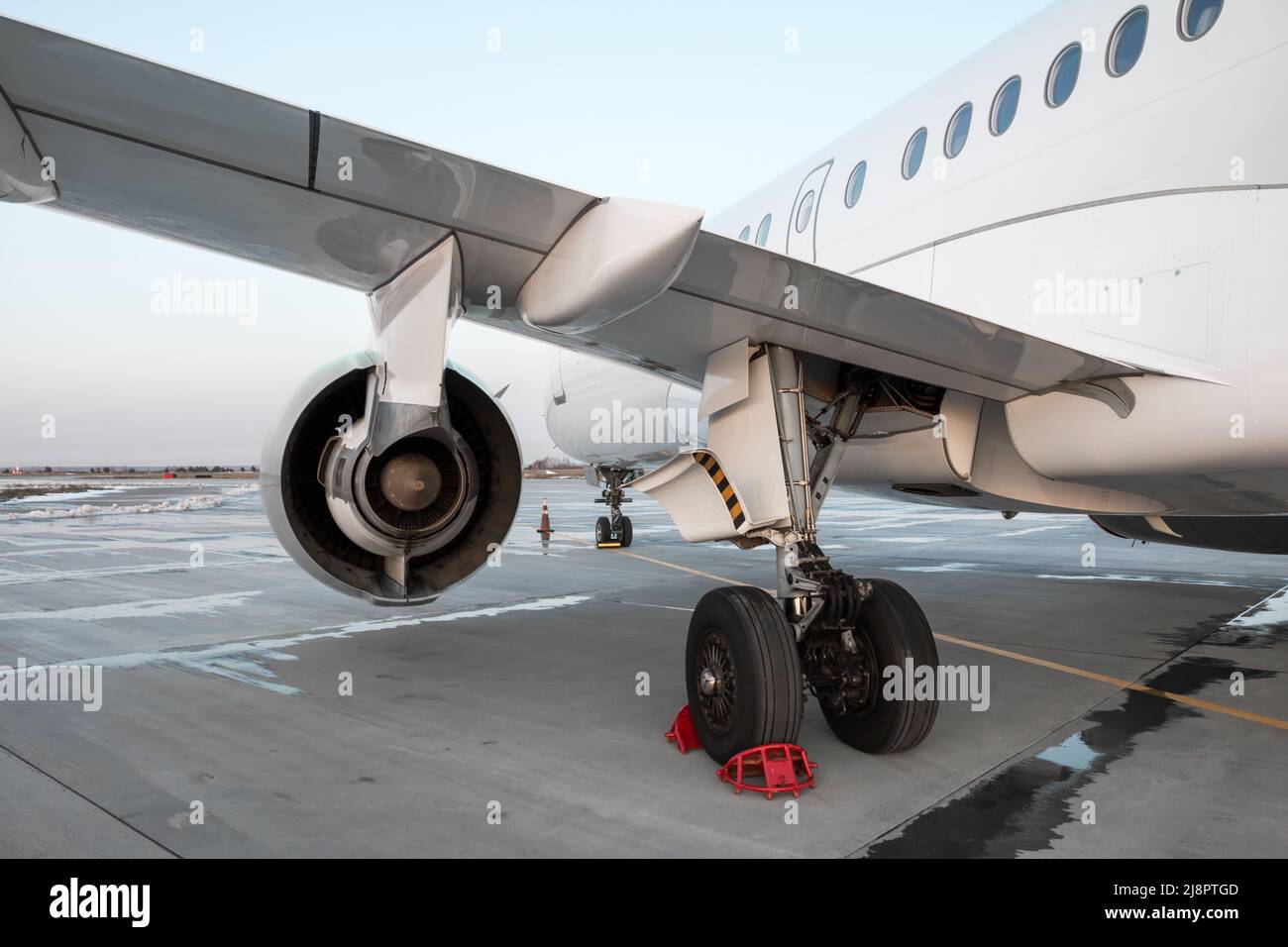 White passenger aircraft on the airport apron. Close-up of rear part of ...