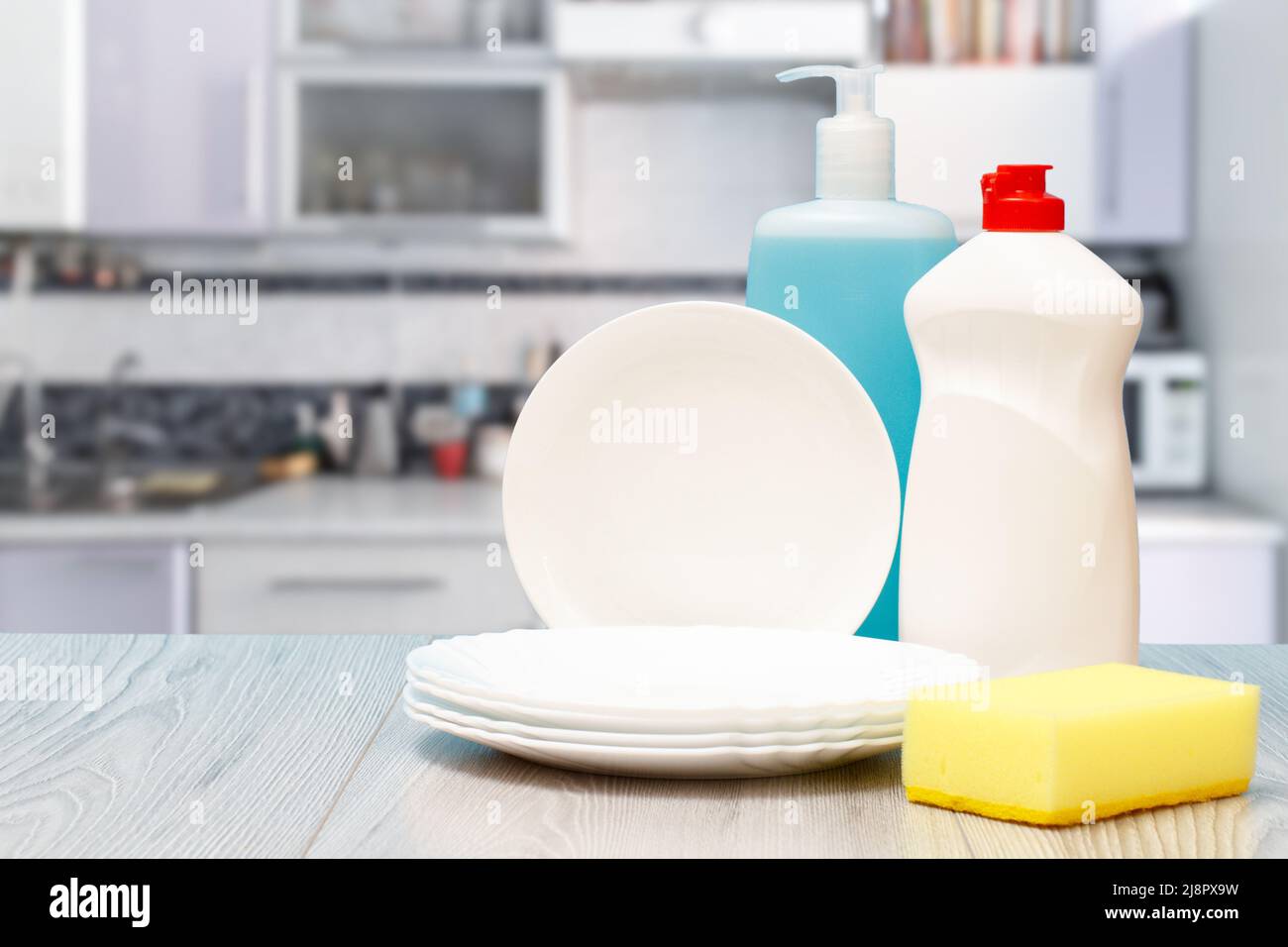 Plastic bottles of dishwashing liquid, glass and tile cleaner, clean ...