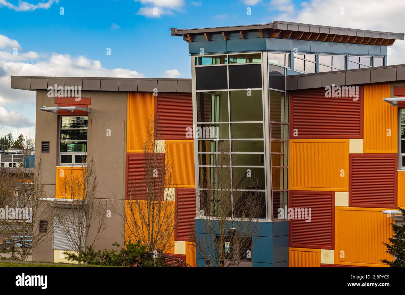 Multi-colored facades of the school with window frames. Modern exterior ...