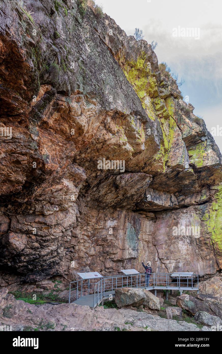 Visitor at Chiquita Cave, rock shelter with prehistorical paintings at ...