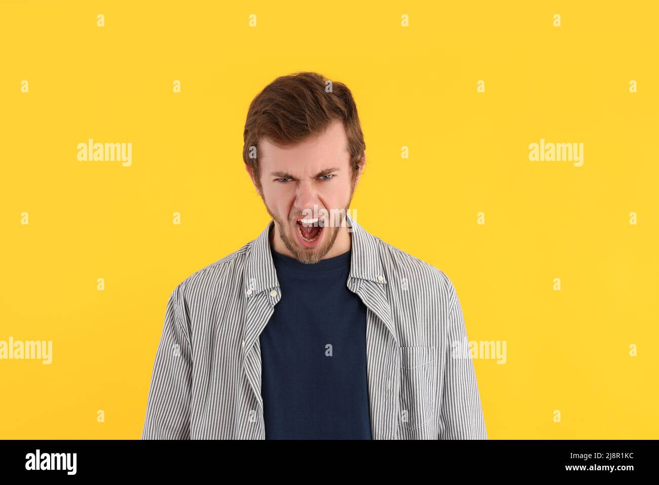 Concept of people, young man on yellow background Stock Photo - Alamy