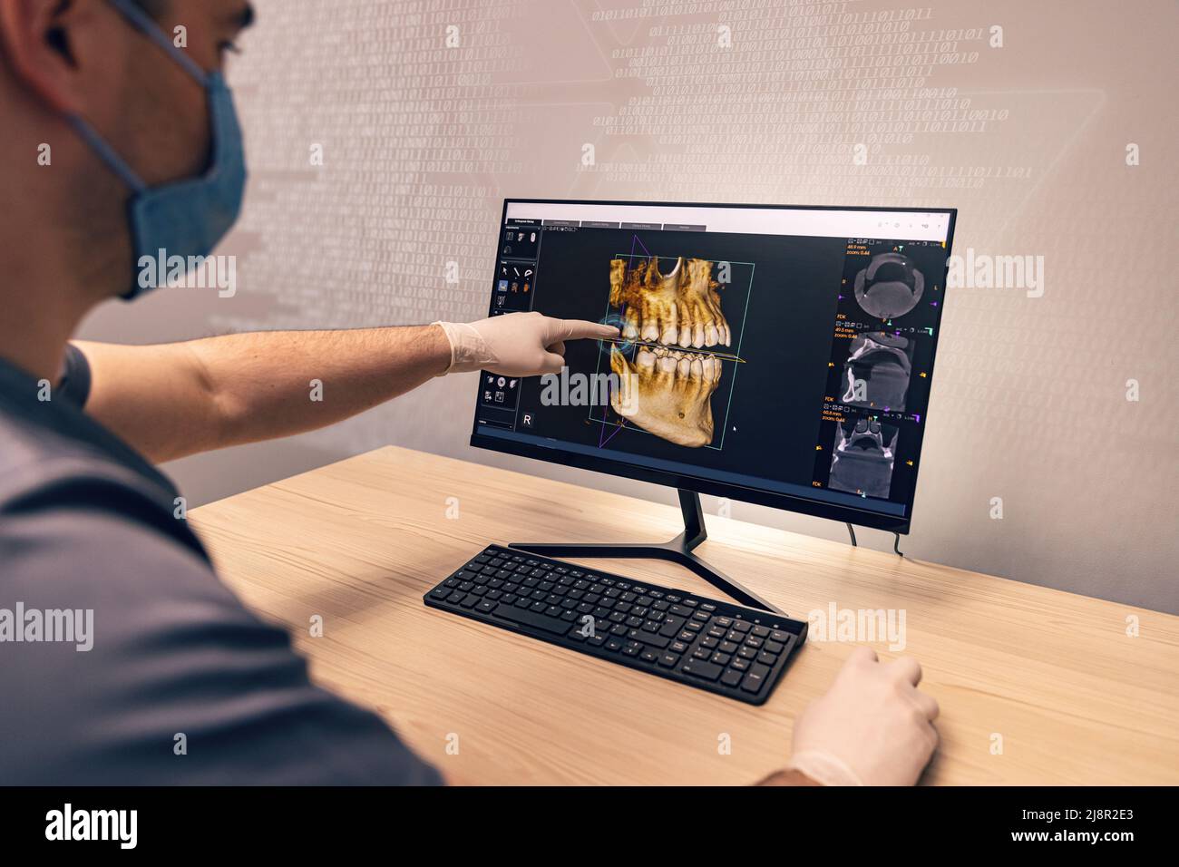 Doctor looking at human teeth x-ray on computer monitor. Modern dental ...