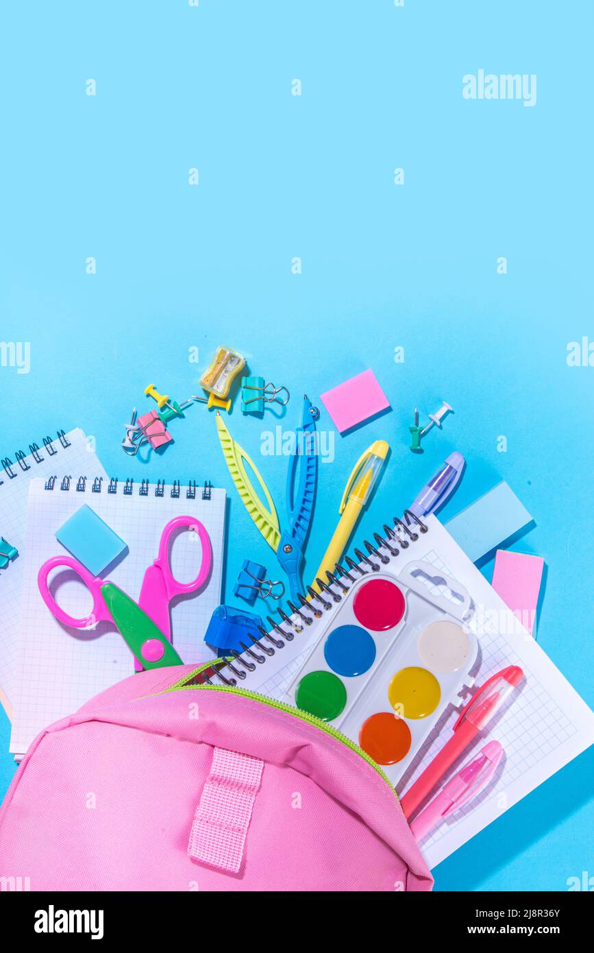 Flat lay background with colorful educational supplies on bright blue ...