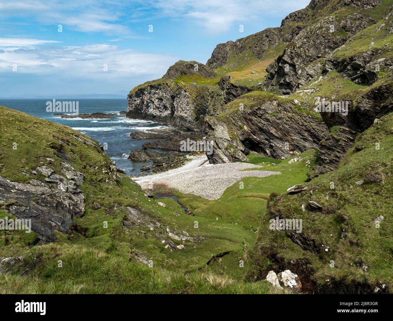 Sea cliffs and pebble beach at Port Ban near Pigs Paradise on the ...