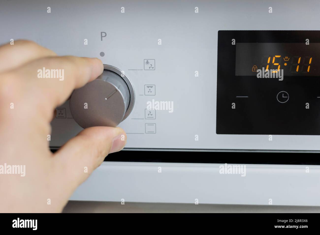 Setting cooking modes and oven temperature. Cooking, baking Stock Photo ...