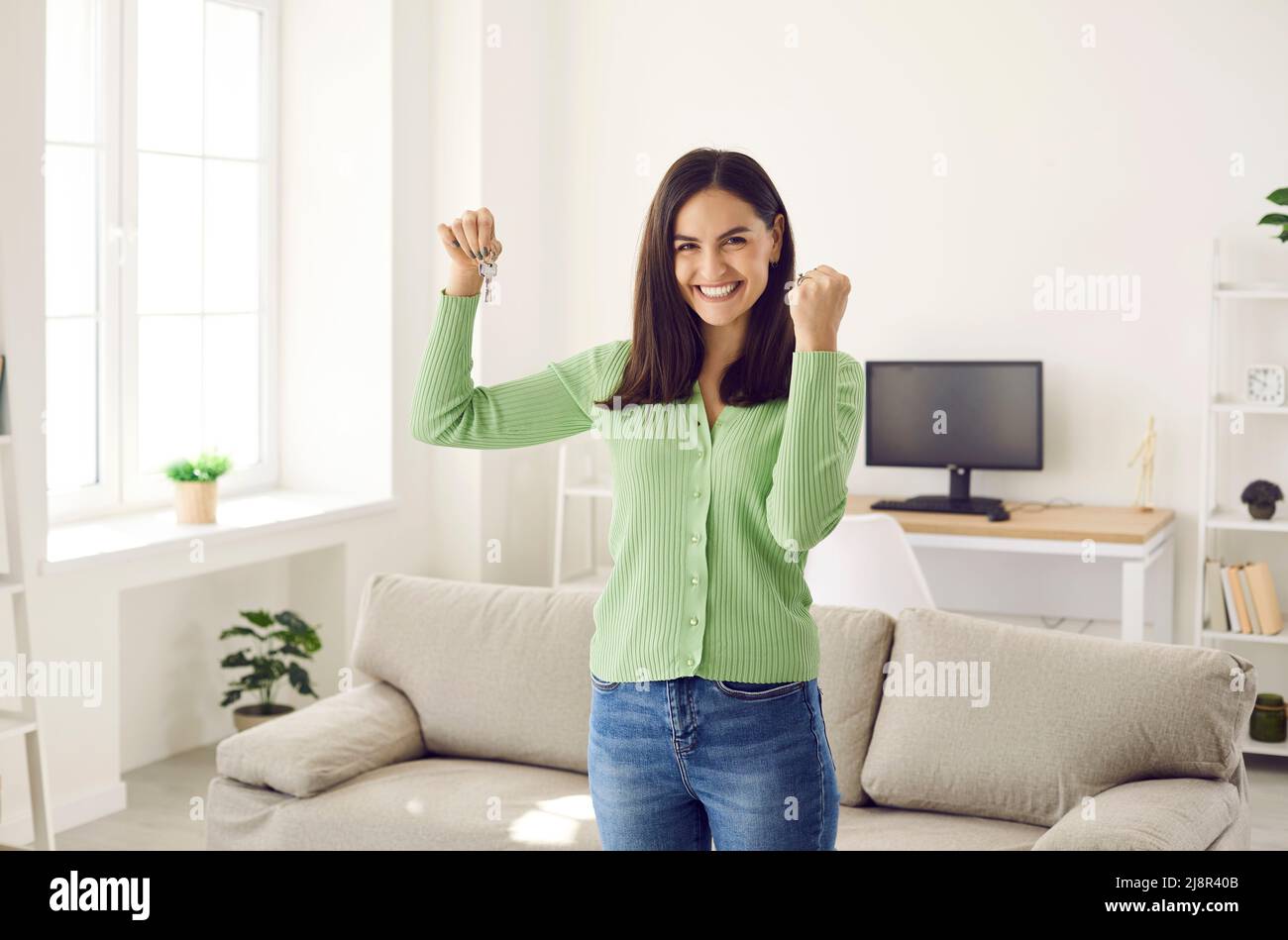 Satisfied lucky woman who is happy that she has finally become owner of ...