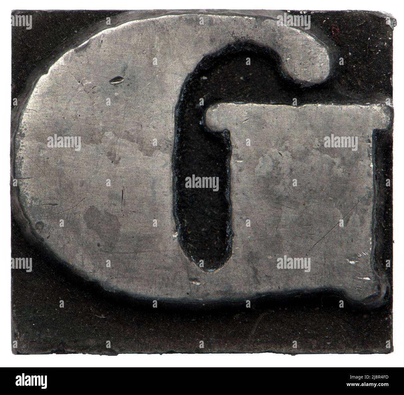 vintage retro macro close-up of uppercase capitol G against white ...