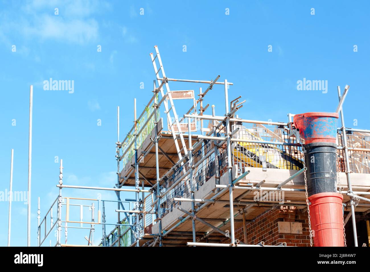 Scaffold installed around houses to provide access for bricklayers and ...