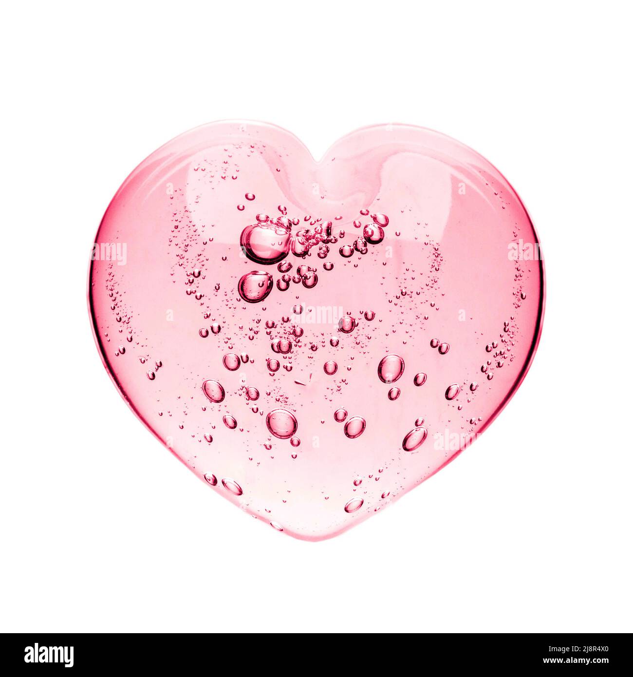Pink serum gel, heart shape puddle isolated on white backdrop, top view ...