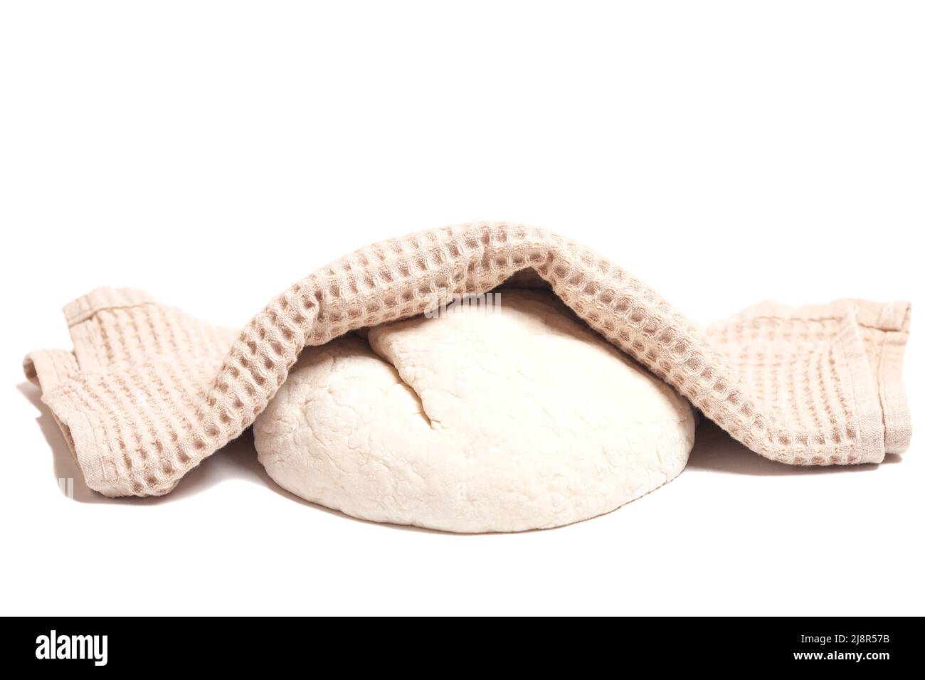 Raw yeast dough covered with a towel. Concept home baking or making ...