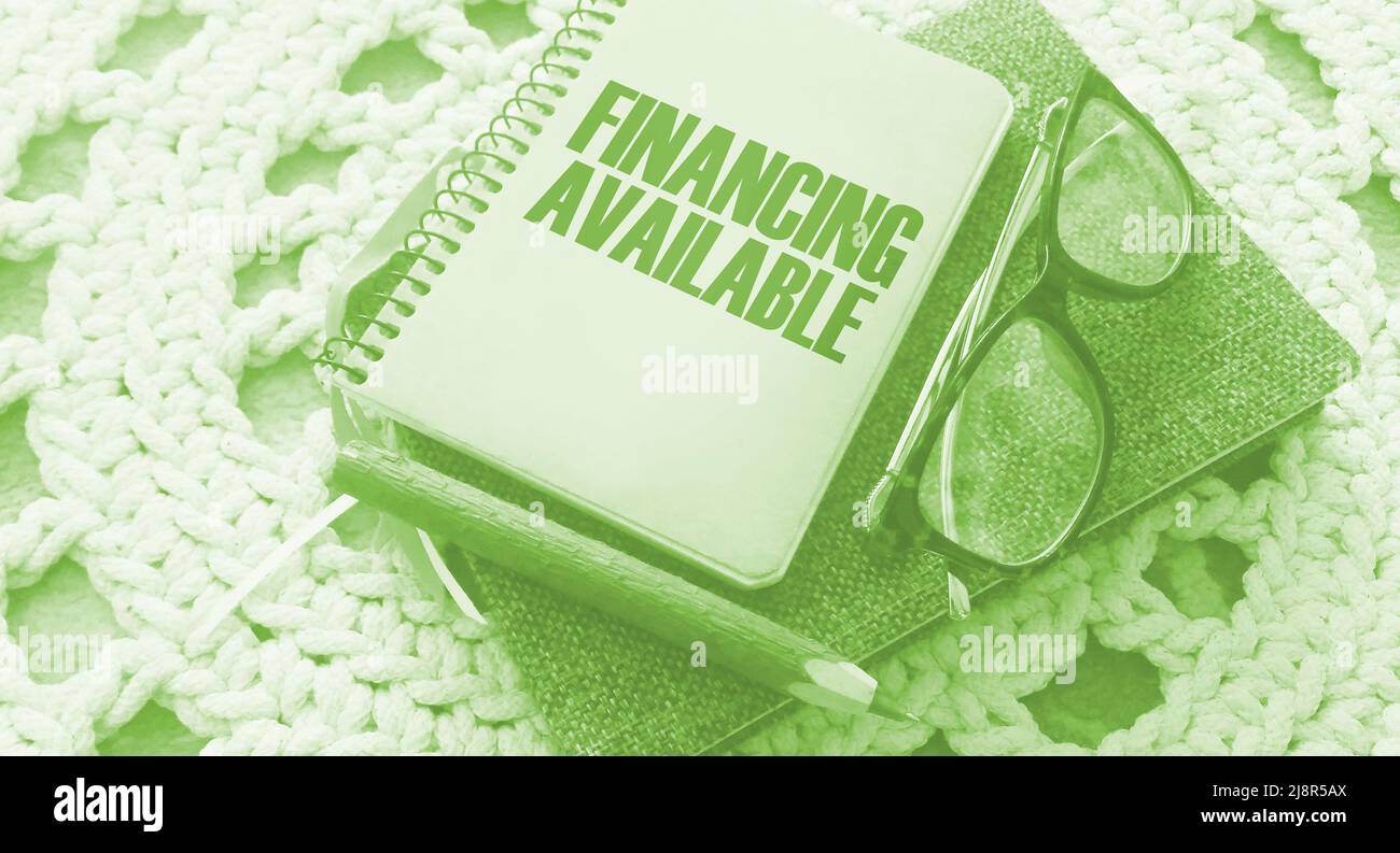 Financial Available words on cover on notebook, glasses and pen ...
