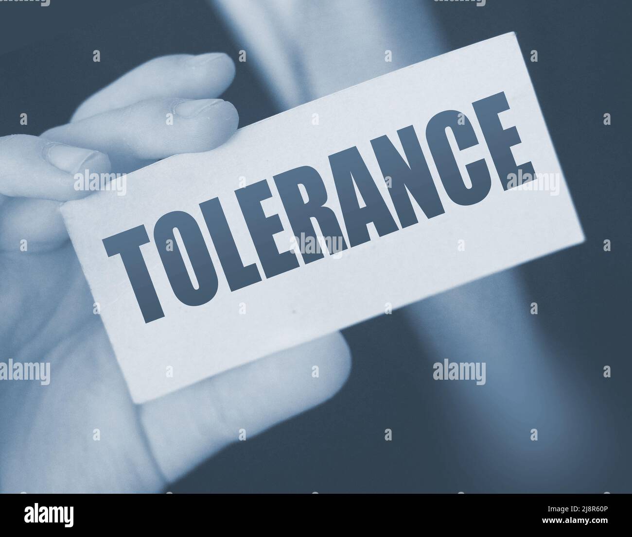 Tolerance words on a card in businessman hand. Social concept against ...