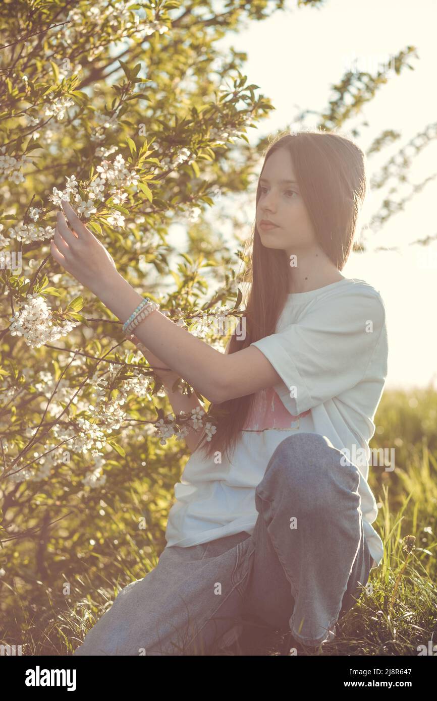 Portrait of a beautiful happy teenage girl outdoors in spring. A girl ...