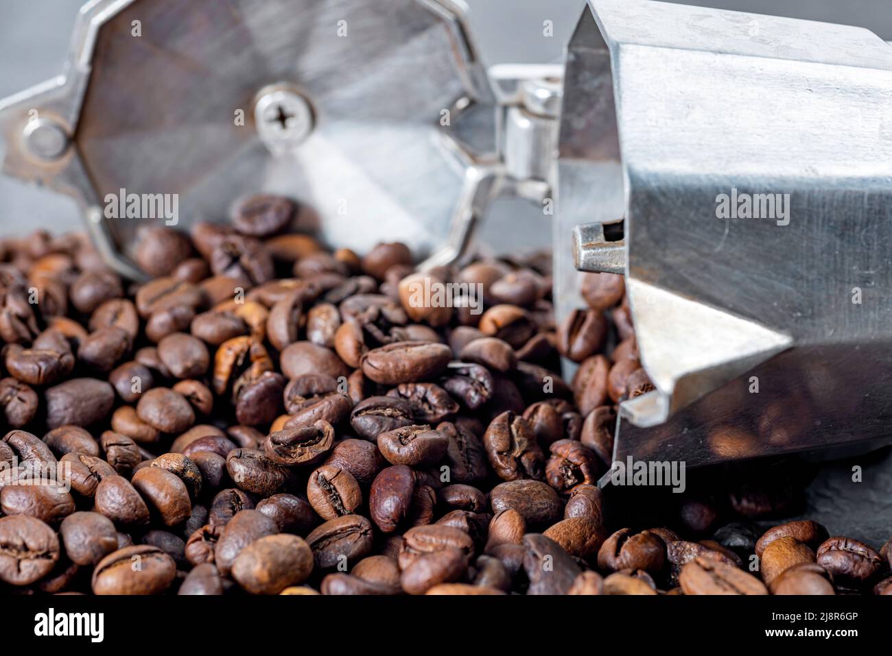 Coffee beans spill from the coffee maker on the textured background ...