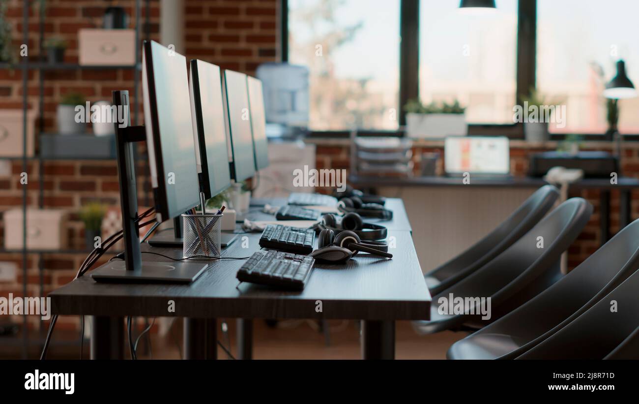 No people at desk with monitors and headphones, workspace prepared for ...