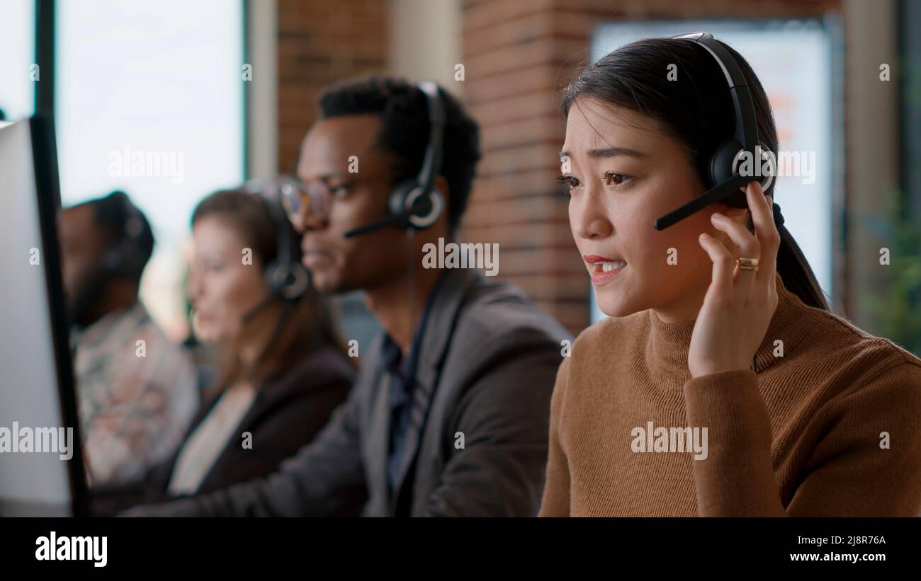 Female sales agent talking on phone call to client, helping people at ...