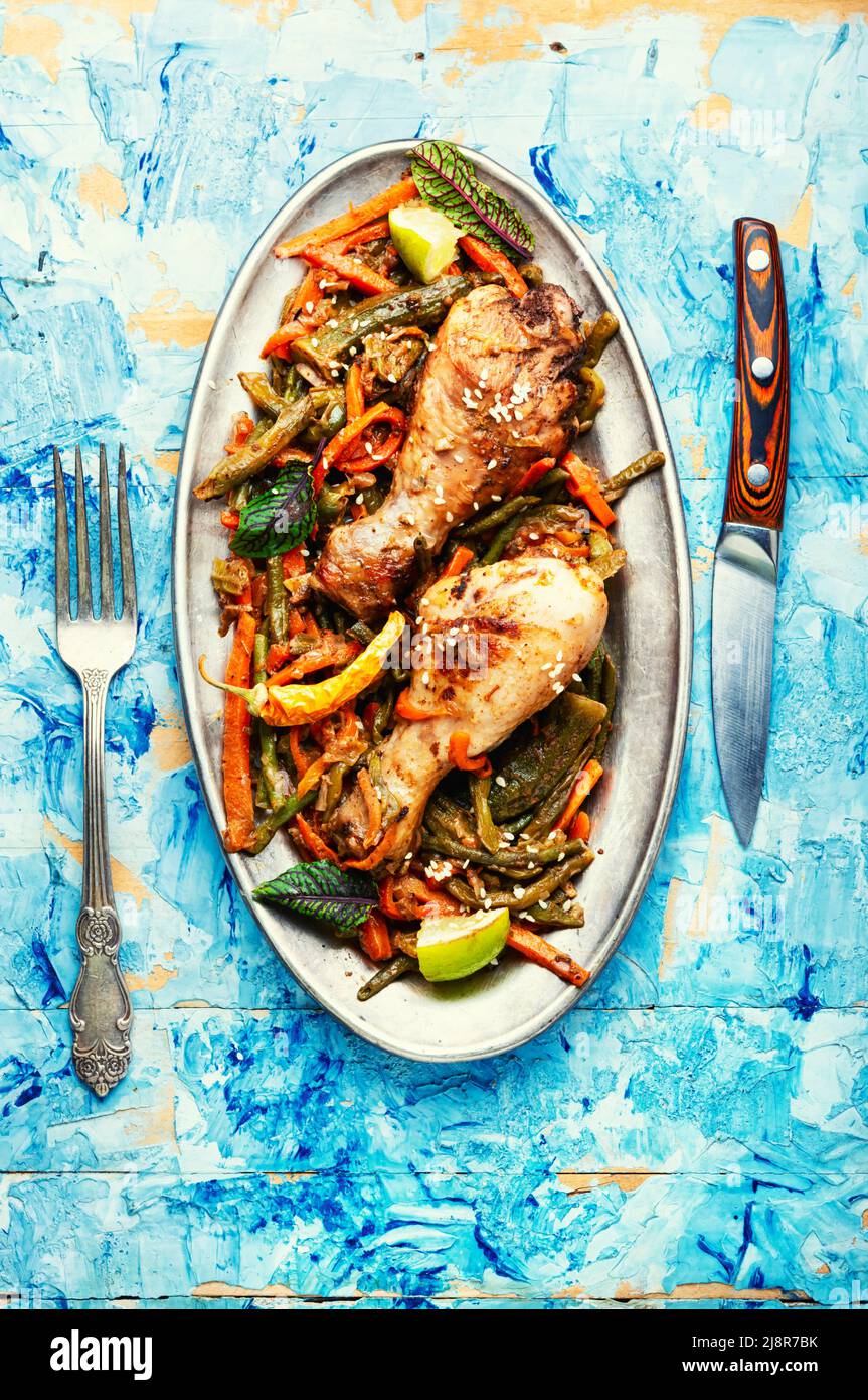 Grilled chicken with vegetable garnish and spices. Fried chicken legs ...