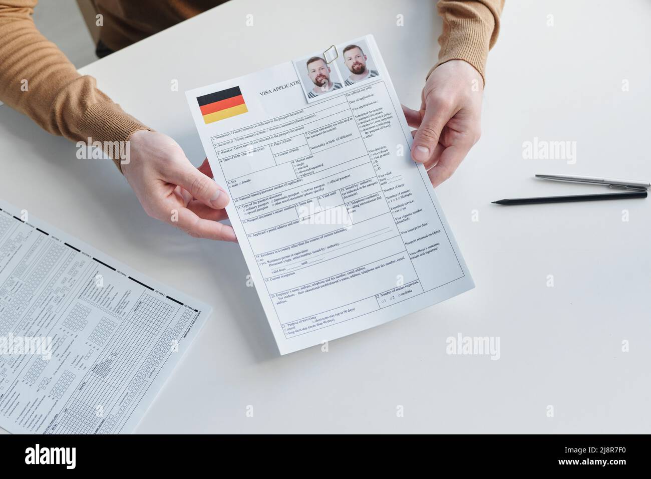 High angle shot of man applying for travel visa in embassy or consulate ...