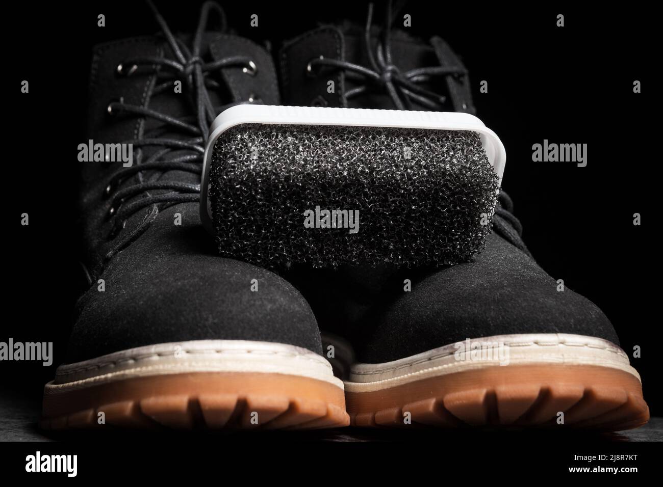 Black foam sponge for suede shoes with black boots Stock Photo - Alamy