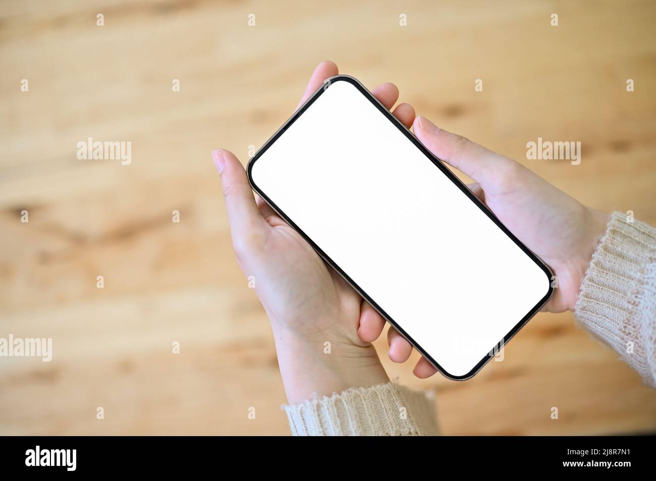 Close-up image, Female hands holding a cellphone white screen mockup ...