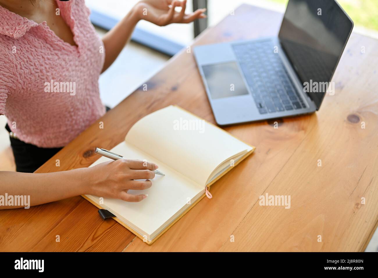 Close-up image, Female college student doing her homework, using laptop ...