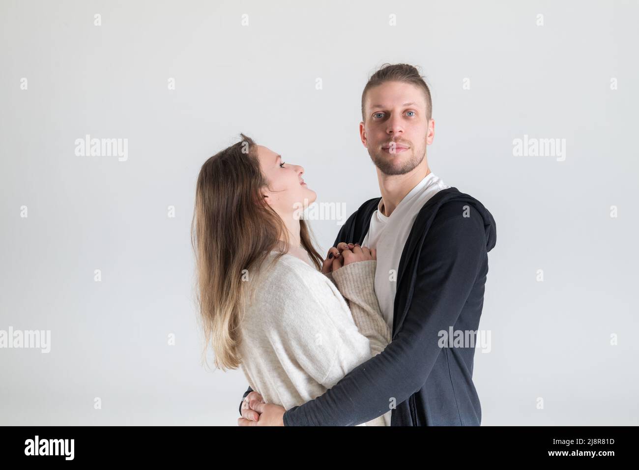 Portrait of a young european couple hugging lovers on a white ...