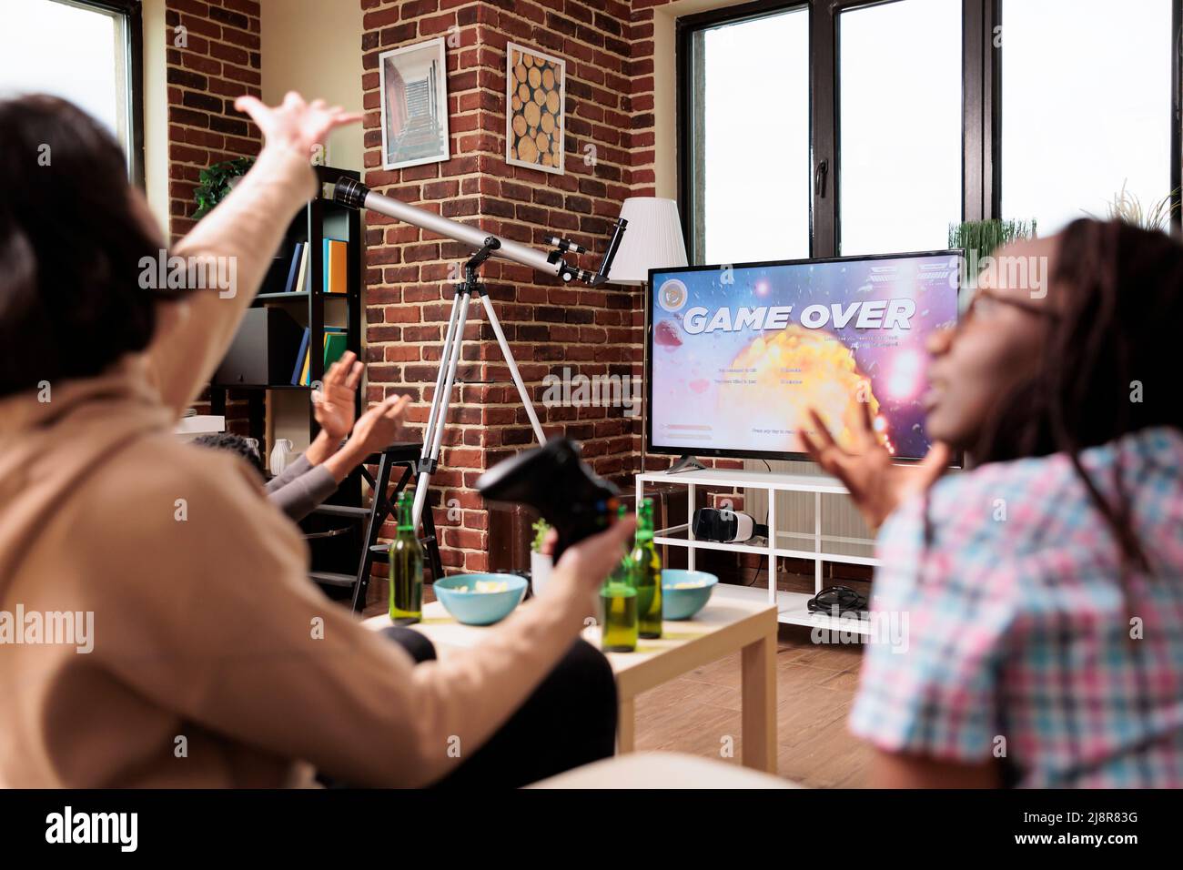 Angry woman reacting to game over screen while losing videogame round ...