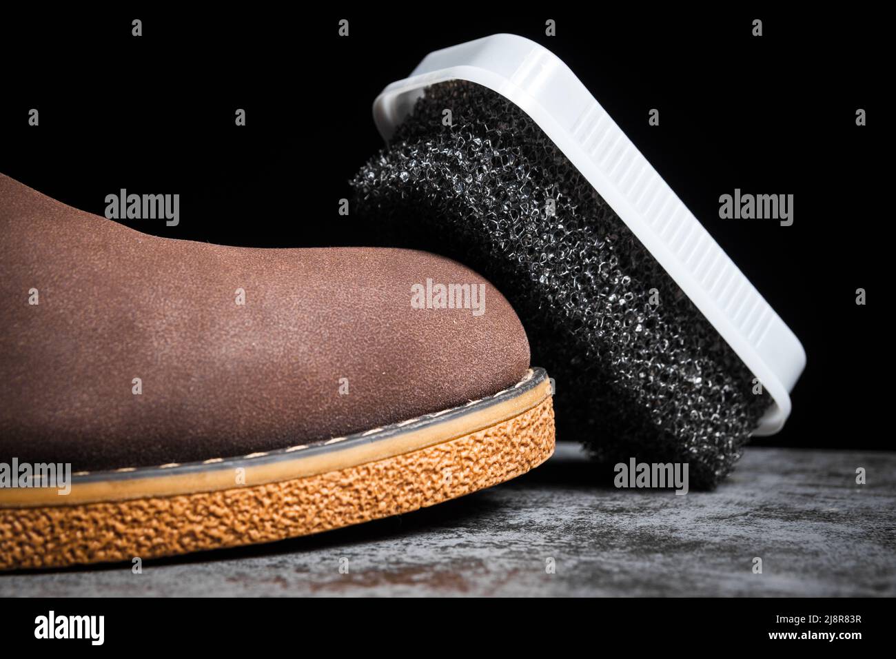 Shoe foam sponge next to a man's brown shoe Stock Photo - Alamy