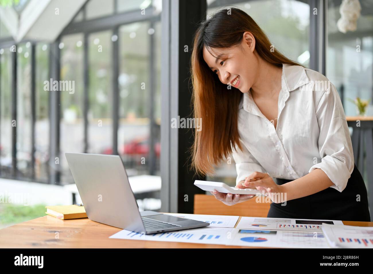 Confident Asian woman accountant or financial analysts working on the ...