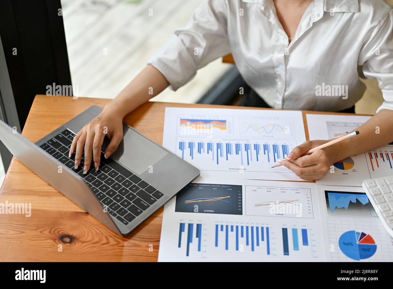 Top view, Female financial accountant working at her office desk, using ...