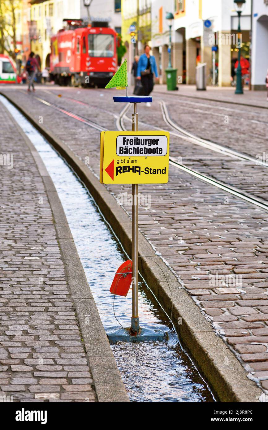 Freiburg, Germany - April 2022: Sign pointing to shop that sells small ...