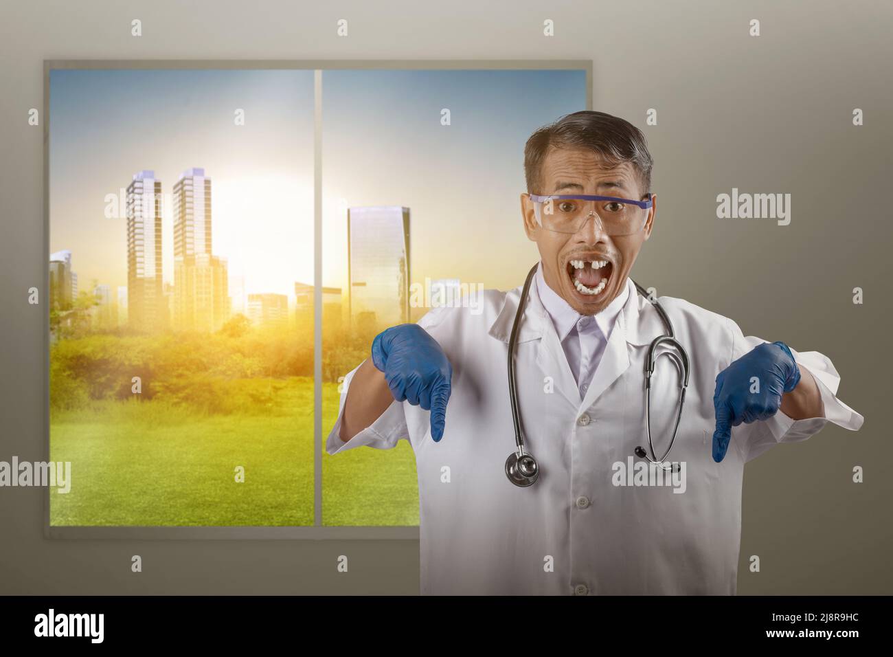 Asian nerd scientist with a stethoscope standing and pointing at ...