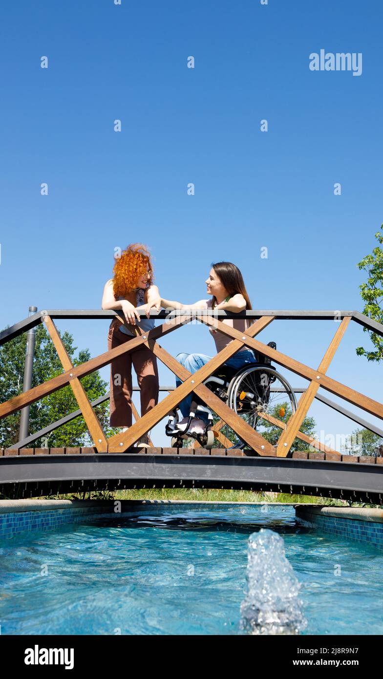 Disabled woman and her friend supporting each other through a ...