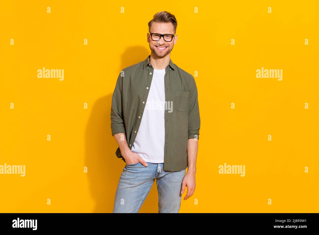 Portrait of attractive cheerful intelligent guy posing wearing specs ...