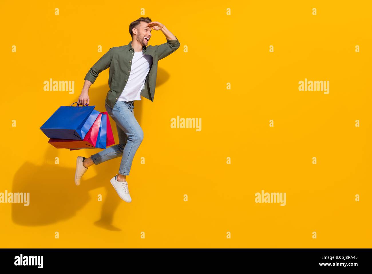 Full length body size view of attractive guy jumping carrying things ...