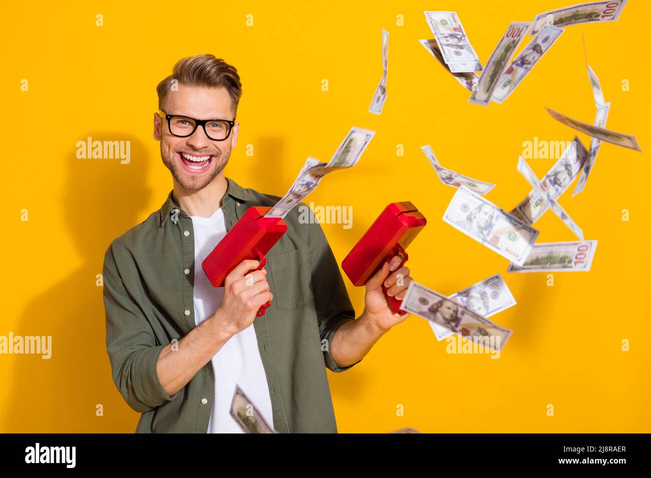 Portrait of attractive trendy cheerful rich guy shooting us money ...