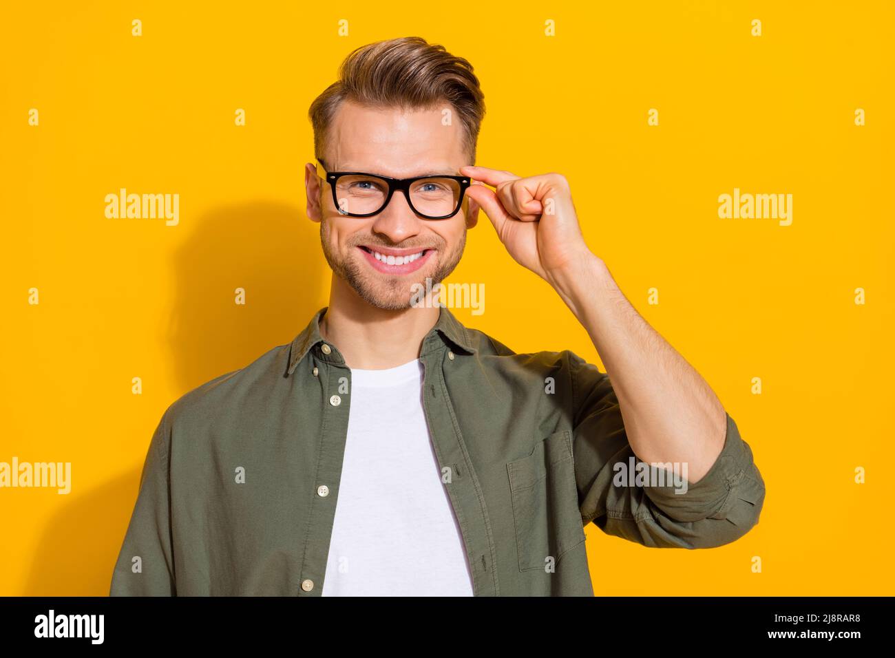 Portrait of attractive cheerful content intellectual guy touching specs ...