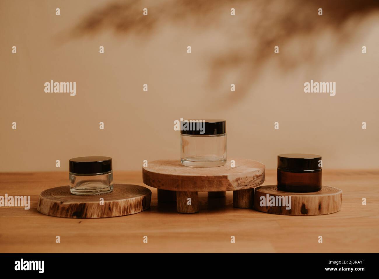 Set of glass containers on wooden platform Stock Photo - Alamy