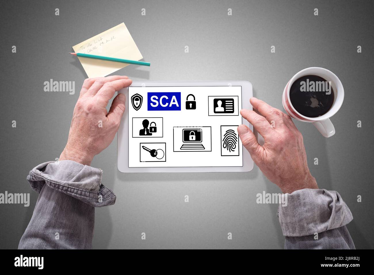 Male hands using a tablet showing sca concept Stock Photo - Alamy