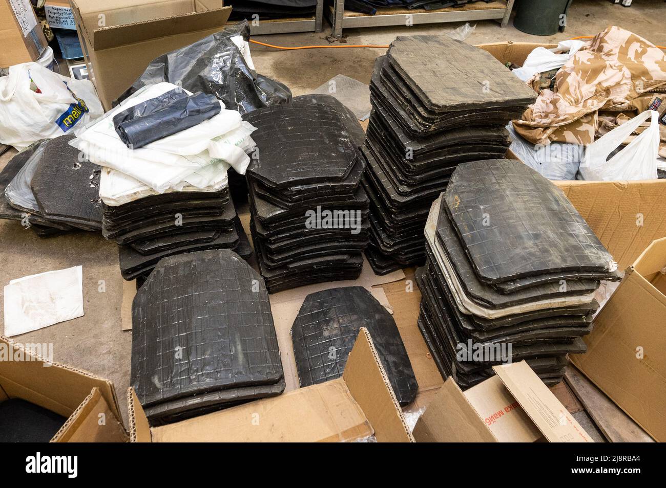 A pile of ballistic / bulletproof plates at a place where supplies are ...