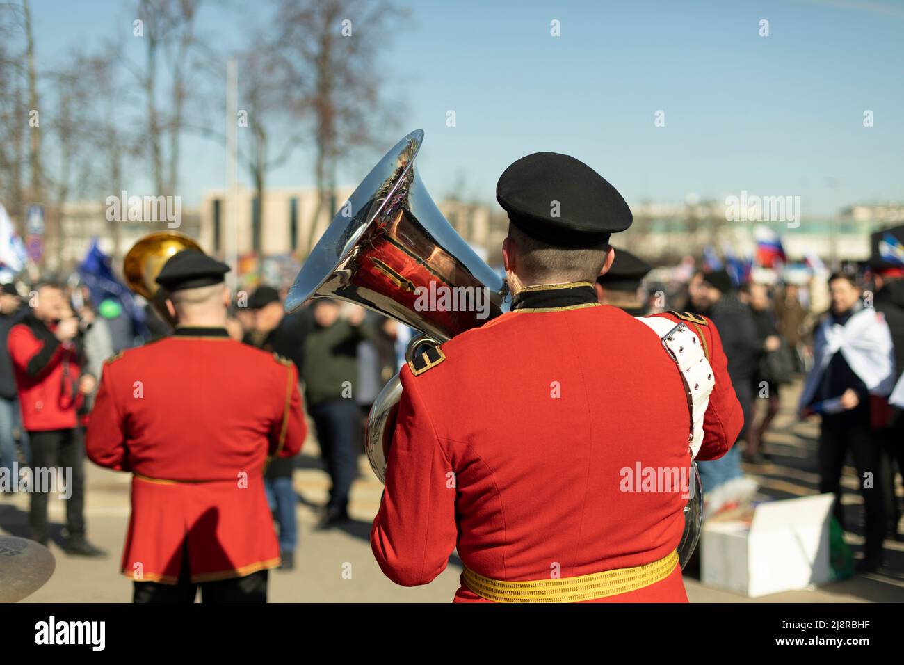 Orchestra with wind instruments. Trumpeters in ceremonial uniforms. Red ...